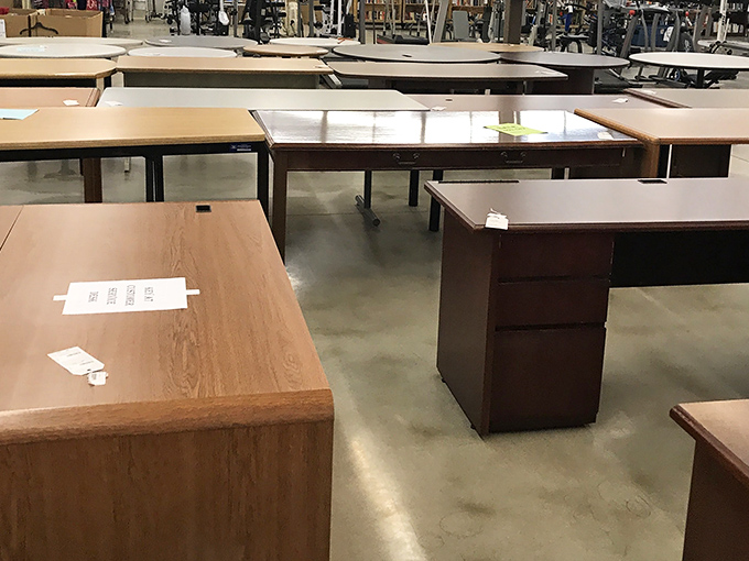 The desk lineup looks like a business meeting of wooden personalities – each with different drawers but similar professional aspirations.