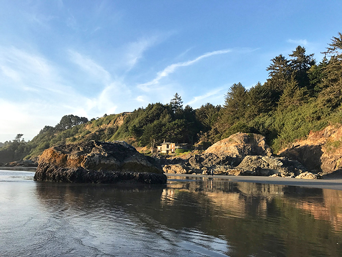 Arcata: The rugged northern California coastline reveals itself through a natural stone arch, framing the wild beauty beyond.
