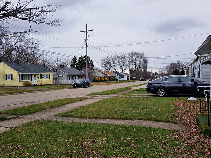 A quiet residential street in Erie, where overcast skies and bare trees mark the change of seasons.