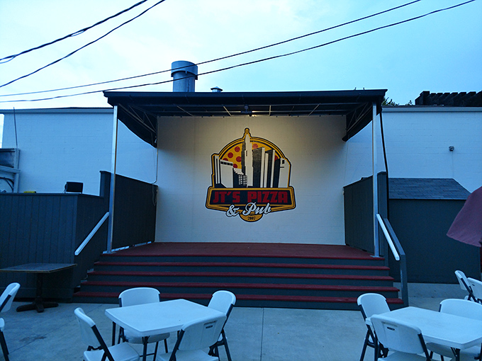 Behind this modest white exterior lies a pizza paradise that locals guard like a precious family secret.