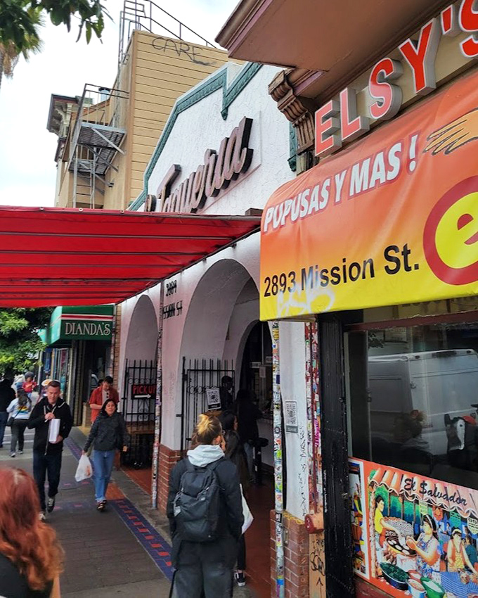 La Taqueria's pink facade and mission-style arches frame a doorway to burrito nirvana in San Francisco's Mission District.