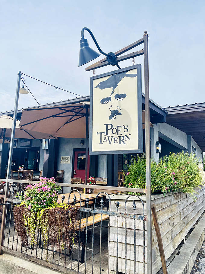 Poe's Tavern sign watches over its domain. Even the literary master himself would approve of these burger masterpieces.