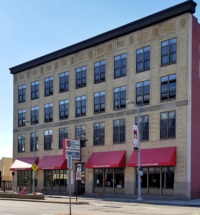 Salvation Army's classic red sign beckons like an old friend. Inside those doors, yesterday's treasures await their second chance at happiness.