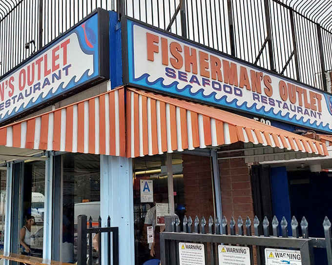 The orange-striped awning at Fisherman's Outlet isn't just eye-catching&mdash;it's a beacon guiding hungry souls to seafood salvation.