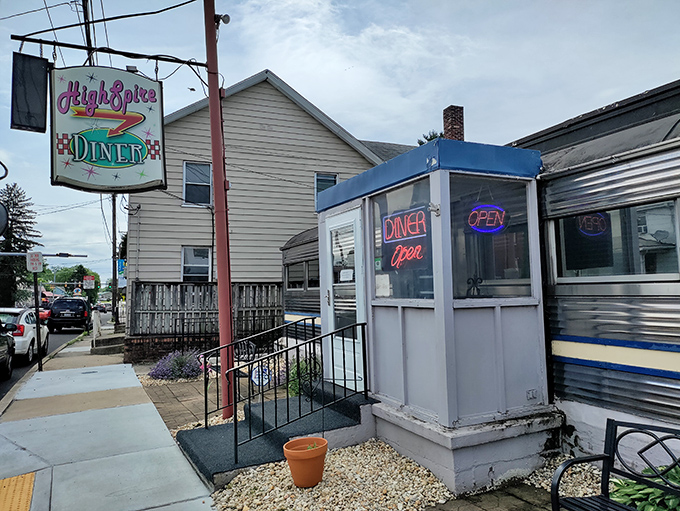 That retro entrance booth with its glowing "OPEN" sign is like a time portal to when diners ruled America's highways.