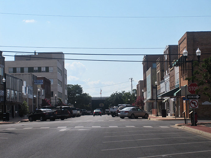 The corner of Main and Yesterday in Lufkin &ndash; where modern cars park alongside vintage dreams.
