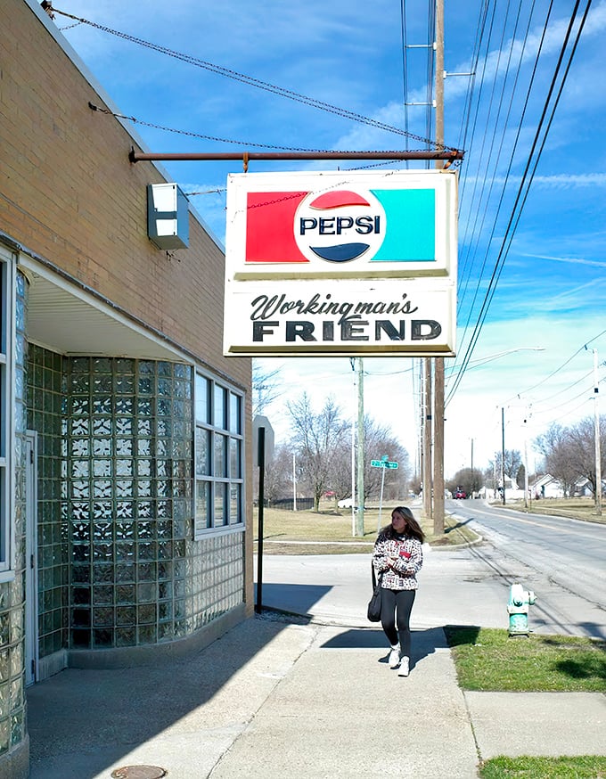 That vintage Pepsi sign and simple storefront scream "authentic" louder than any hipster joint ever could.