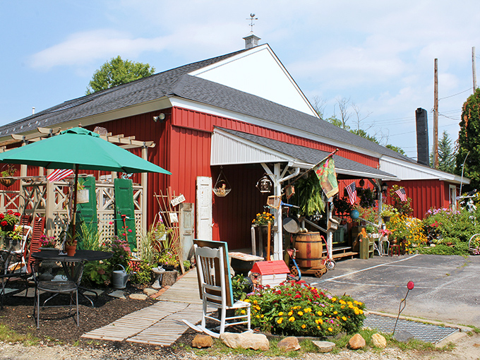 Garden treasures and weathered wonders await outside this red barn where yesterday's tools become today's conversation pieces.