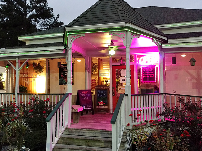 When the sun sets, Village Steakhouse transforms into a neon-lit wonderland of beef and good times. That pink glow practically whispers "come hungry."