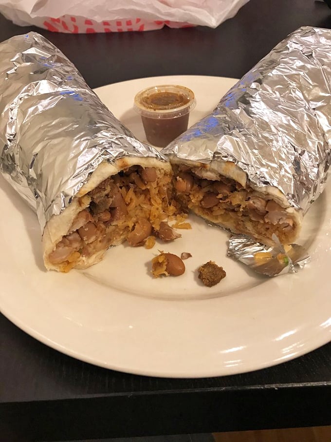 The legendary burrito, sliced to reveal its inner treasure. Like a delicious geological cross-section of flavor strata, each layer promising its own delightful experience.