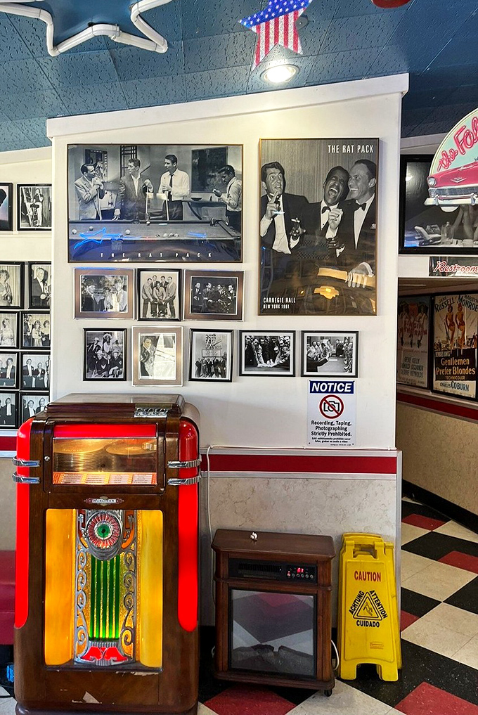 The vintage jukebox stands guard beside Rat Pack memorabilia, silently judging your music choices while reminding you what cool actually looked like.