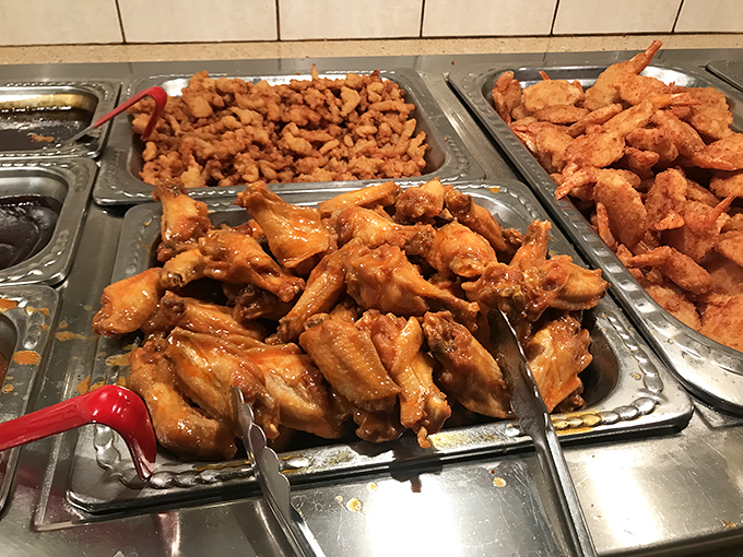 Buffalo wings glistening with sauce next to golden fried delights&mdash;proof that buffets can be about quality, not just quantity. A trifecta of crispy, tender, and saucy.