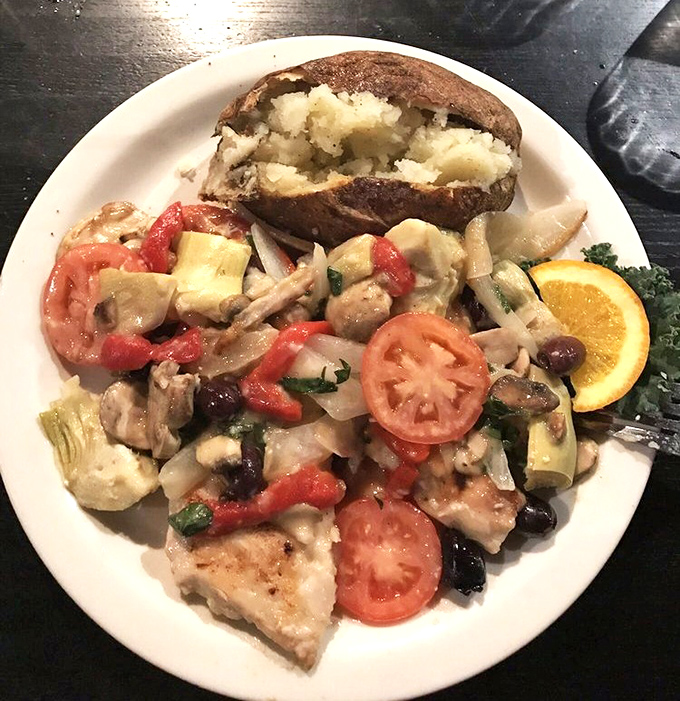 A Mediterranean vacation on a plate&mdash;chicken nestled among colorful vegetables and tomatoes, proving that healthy eating doesn't have to be a punishment.
