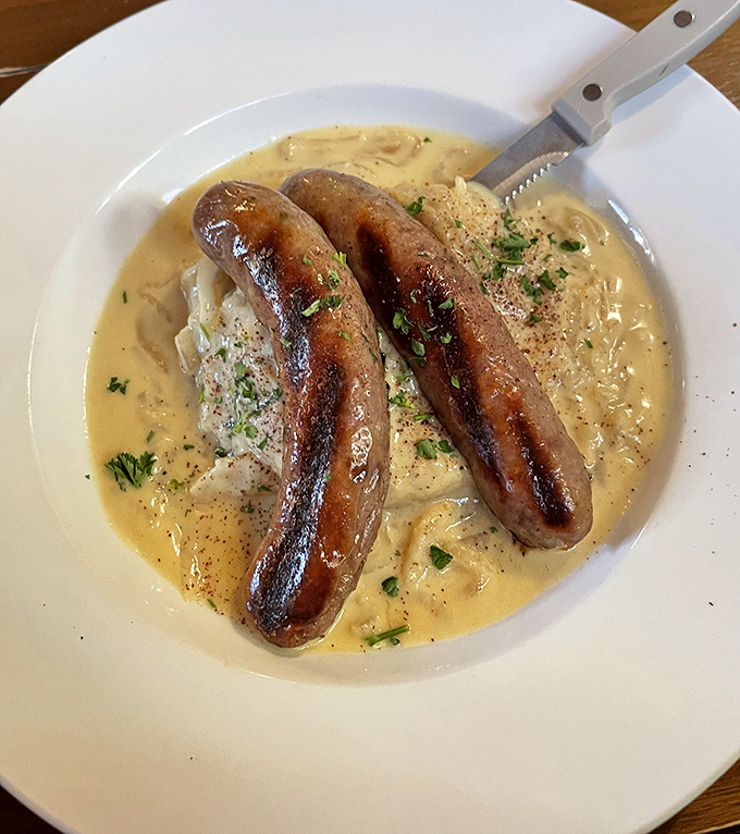 These bangers aren't just singing &ndash; they're performing a full symphony atop creamy mashed potatoes in a pool of savory gravy.