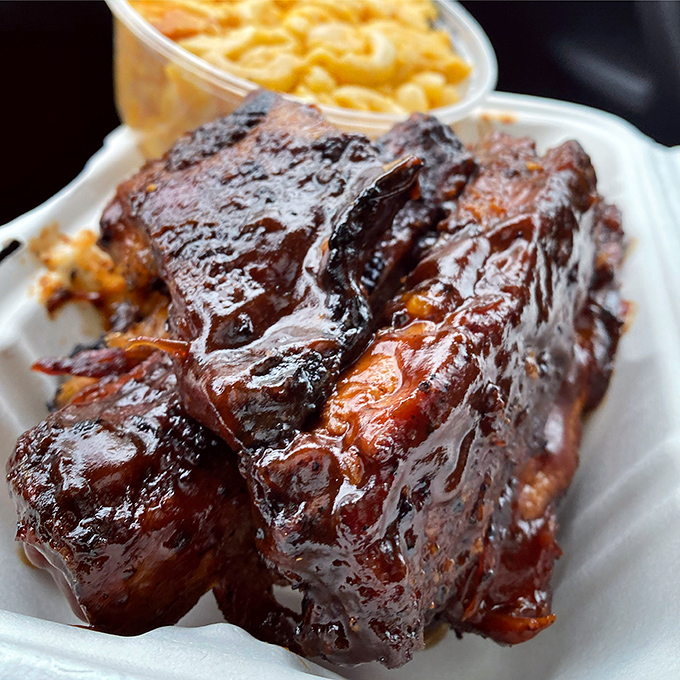 Ribs that make you reconsider your life choices. Why haven't you been eating these every day? The glaze catches light like stained glass in a cathedral of BBQ.