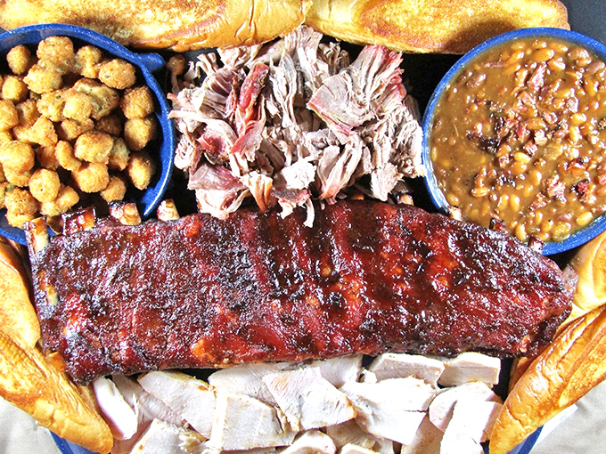 A barbecue masterpiece: ribs with that perfect pink smoke ring, pulled pork with ideal texture, and sides that aren't afterthoughts but co-stars in this meaty drama.