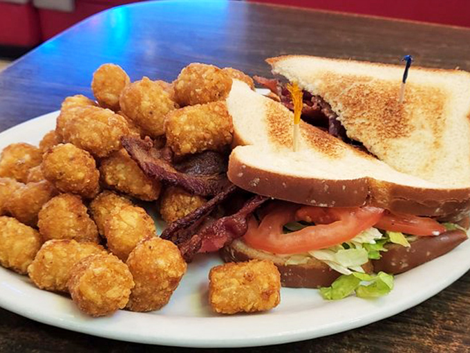 This isn't just a BLT&mdash;it's architecture with bacon. Perfectly toasted bread, garden-fresh tomato, and those tater tots deserve their own zip code.