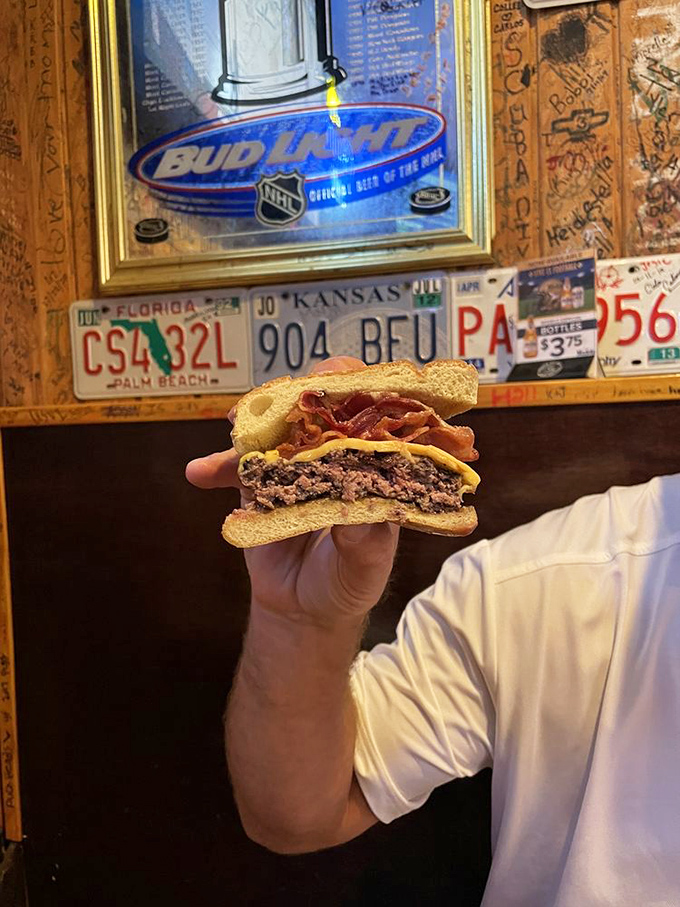 The cross-section reveals the truth—this burger means business. Melted cheese, crispy bacon, and beef cooked exactly how the burger gods intended.