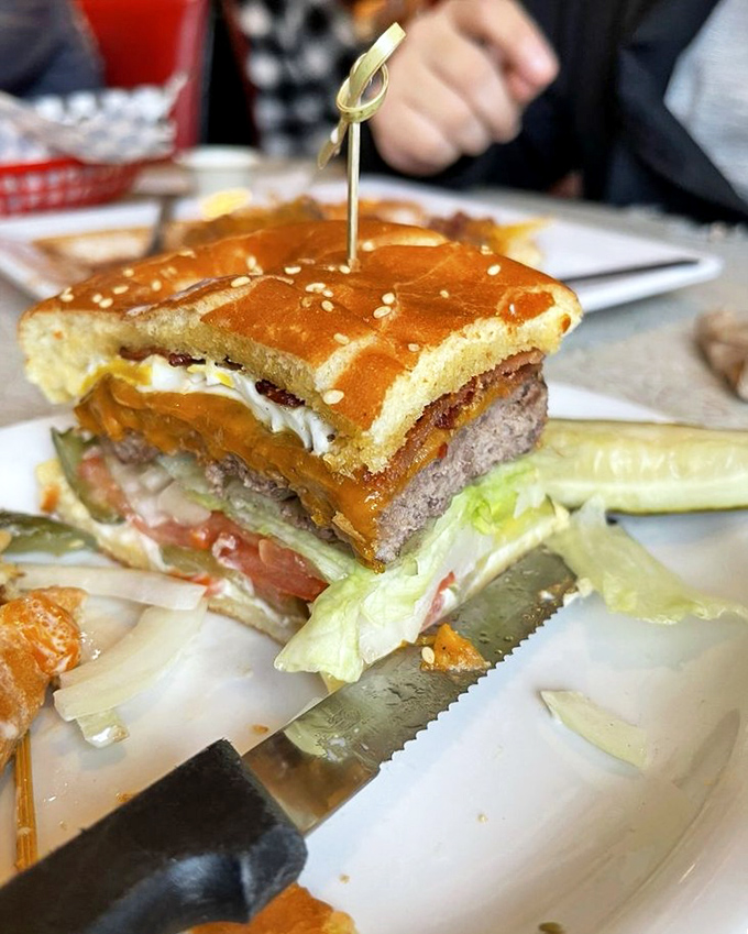 Architecture that makes sense: a towering burger built for maximum flavor impact. That golden cheese melt is pure poetry.