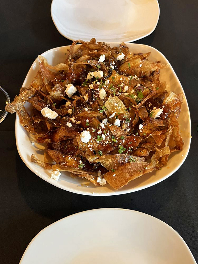 The famous bacon citrus chips&mdash;a mountain of crispy potato slices, bacon bits, and feta that'll make you forget potato chips ever existed.