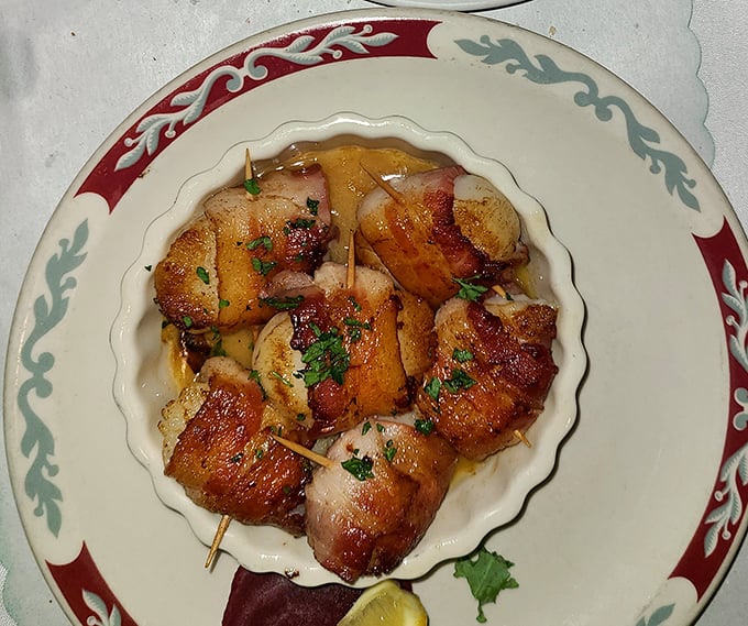 Bacon-wrapped scallops: proof that sometimes the best relationships are the simplest ones. The bacon's crisp embrace around each tender scallop is romance on a plate.