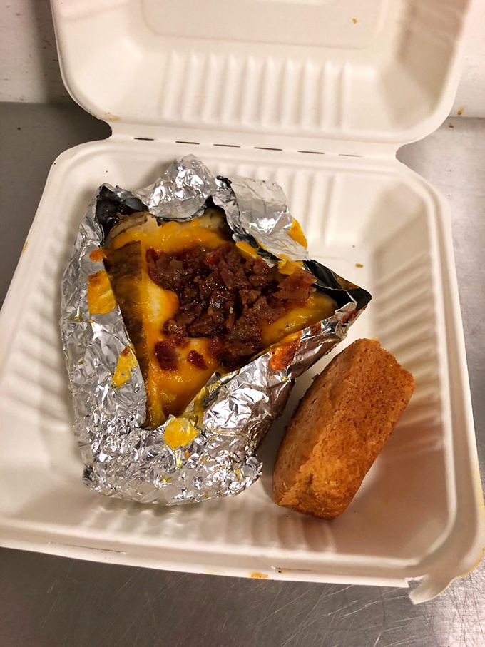 A foil-wrapped potato transformed into edible architecture&mdash;proof that sometimes the best things come wrapped like presents.