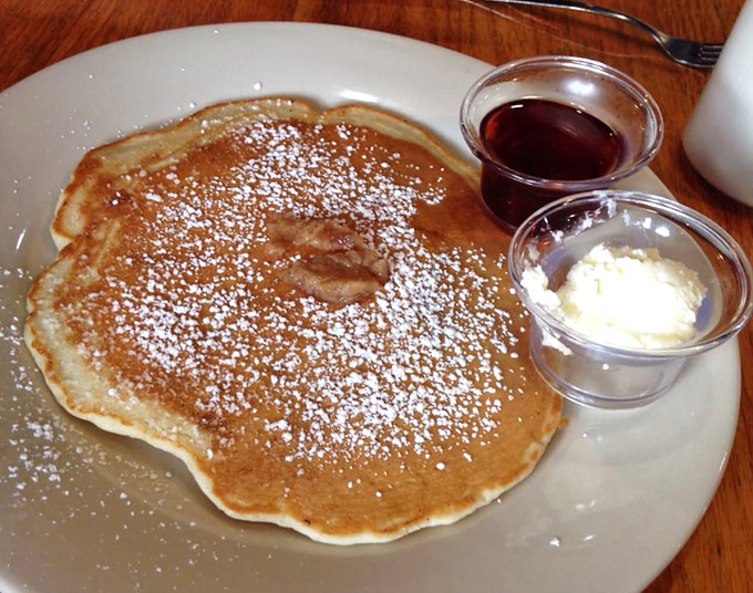This pancake doesn't just sit on the plate&mdash;it commands attention with its golden hue and perfect dusting of powdered sugar.