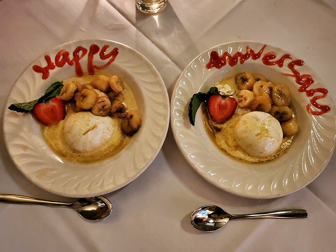 "Happy Anniversary" written in sauce alongside caramelized bananas and ice cream&mdash;proof that the best celebrations always end with something flamb&eacute;ed.