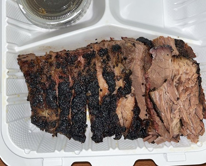 Brisket with a bark so perfect it belongs in a museum. The pink smoke ring is nature's way of saying "you're welcome."