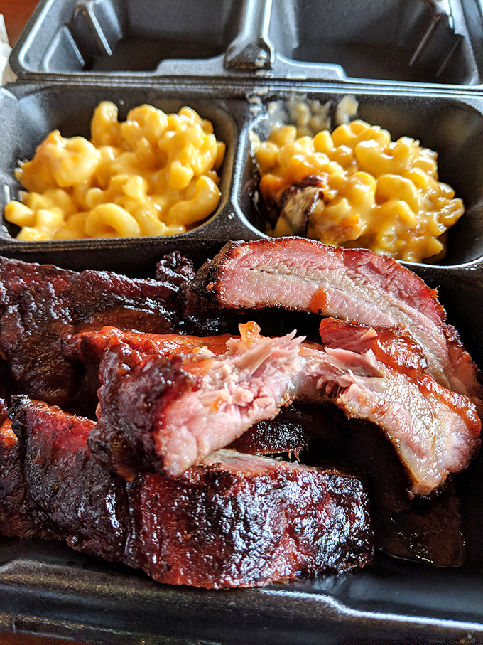 Behold the sacred smoke ring—that pink perimeter that separates barbecue artistry from mere cooking. The mac and cheese isn't looking too shabby either.