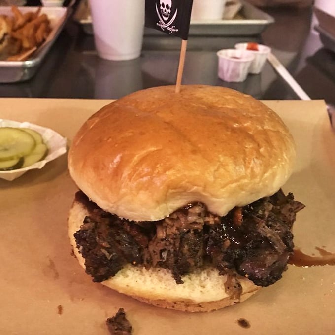 This brisket sandwich flies a tiny pirate flag because it knows it's committed highway robbery on your taste buds. Worth every delicious bite.