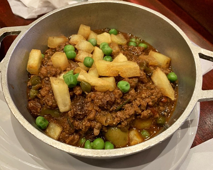 Picadillo criollo—where ground beef meets sweet raisins, salty olives, and crispy potatoes in a dance of flavors that's pure Cuban comfort.