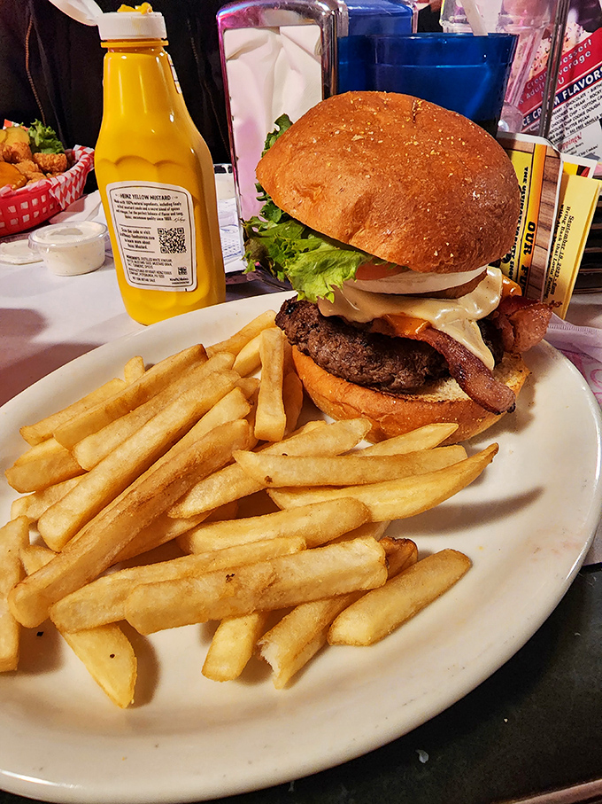 A burger that requires a game plan before the first bite. That stack isn't just lunch&mdash;it's an engineering marvel with fries.