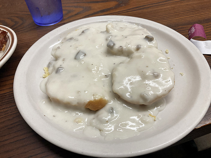 Biscuits and gravy so authentic they should come with their own Southern accent. That gravy blanket looks like it's tucking those biscuits in for a delicious nap.