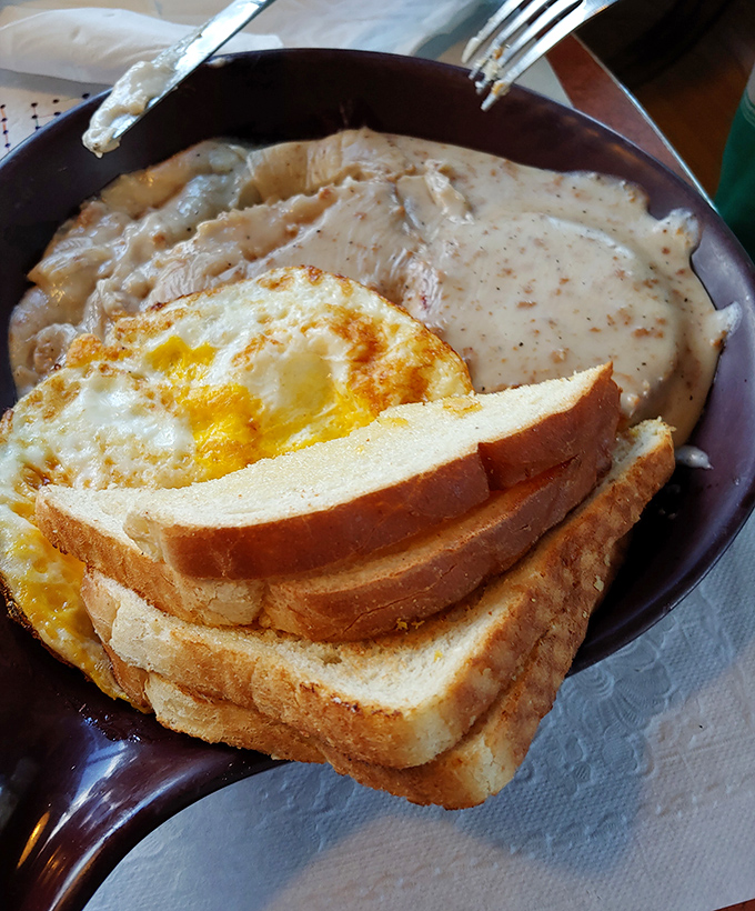 Biscuits swimming in creamy sausage gravy with a sunny-side egg &ndash; Southern comfort that somehow found its way to Wisconsin and decided to stay.