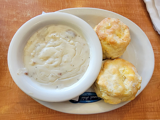 Biscuits so fluffy they could double as pillows, swimming in gravy that's clearly been simmering since dawn. Southern comfort in a bowl.