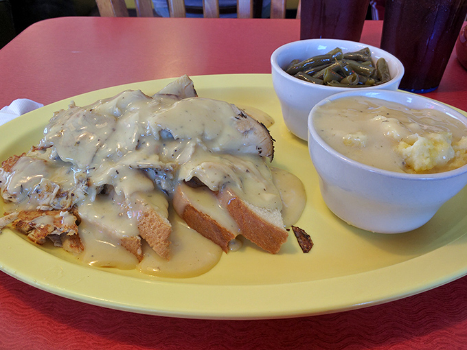 Biscuits smothered in creamy gravy alongside green beans and mashed potatoes&mdash;the Southern comfort food trifecta that hugs your soul.