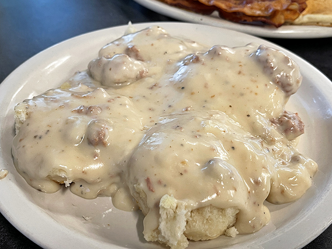 Biscuits and gravy that don't know the meaning of restraint—a creamy, savory blanket of comfort that your grandmother would approve of, but could never admit to.