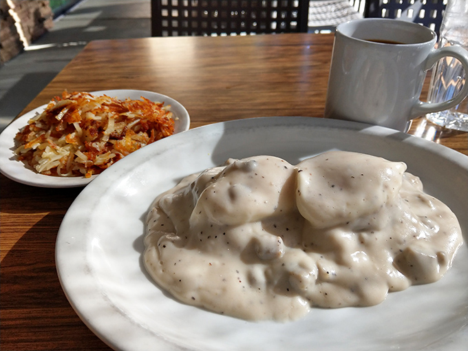Biscuits drowning in sausage gravy - Southern comfort food that hugs your soul from within.
