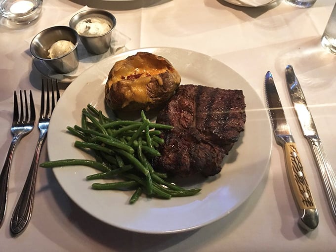 This isn't just dinner; it's architecture. The baked potato and green beans know they're in the presence of greatness with this perfectly cooked steak.