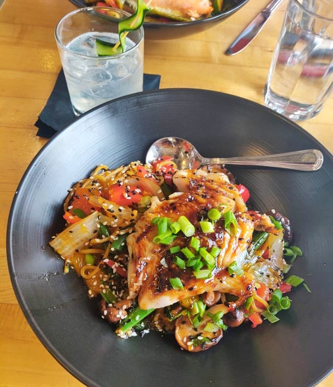 A symphony of colors, textures, and flavors that makes ordinary takeout seem like a sad country song. This noodle dish proves seafood and Asian flavors are soulmates.