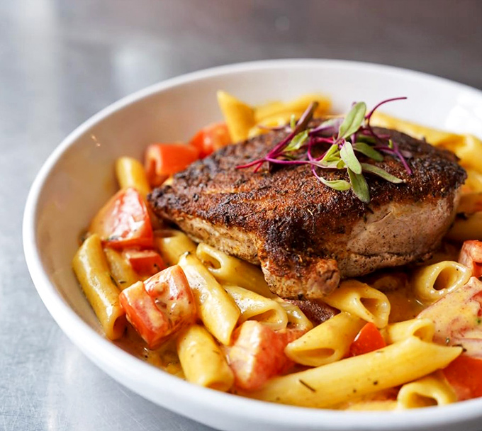 Blackened tuna that didn't get the memo about being subtle, lounging on pasta like it owns the place.