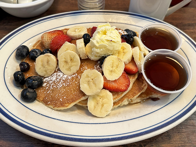 Pancake perfection that would make IHOP executives weep. Fresh berries, bananas, and whipped cream create a breakfast that's basically acceptable morning dessert.