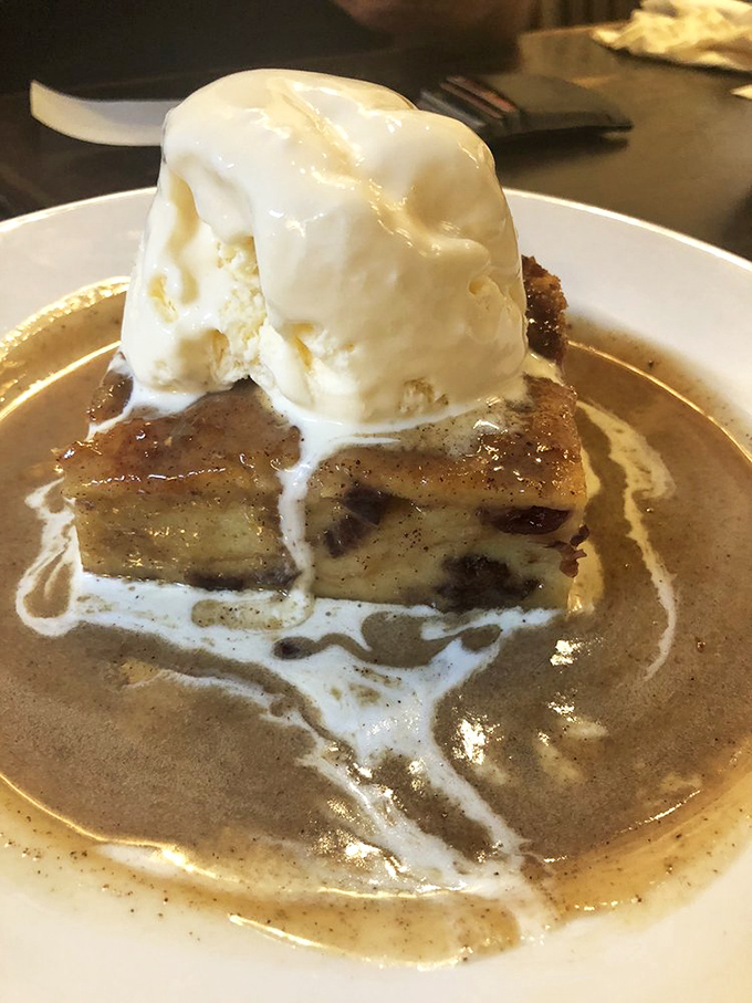 Bread pudding that would make your grandmother both jealous and proud, crowned with ice cream melting into a sweet surrender.