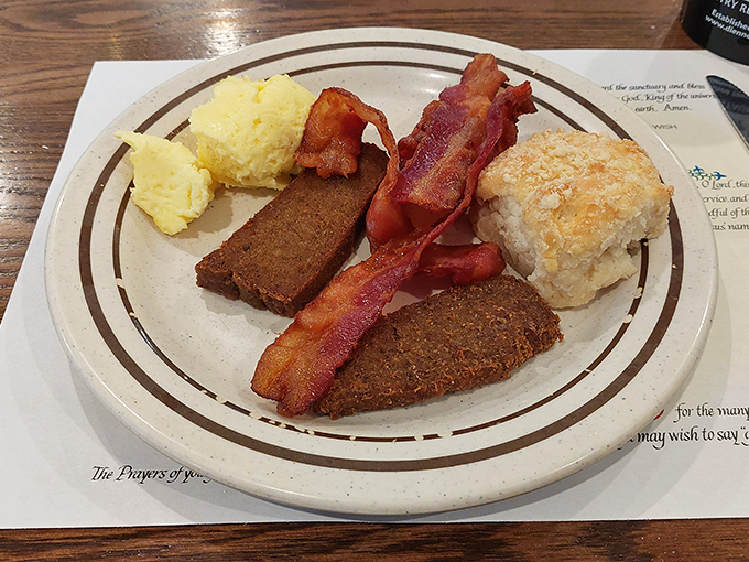 Breakfast of champions: crispy scrapple, perfectly cooked bacon, and a golden biscuit that could make a carb-counter weep with joy.