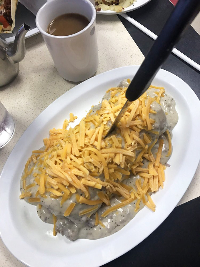 Country gravy blankets this breakfast with the kind of comforting embrace that makes Monday mornings slightly more bearable.