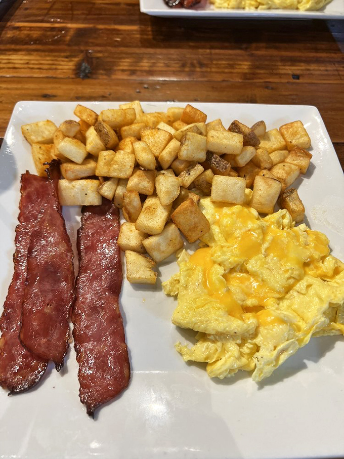 The breakfast trinity: perfectly cooked eggs, crispy bacon, and those legendary home fries. Simple? Yes. Ordinary? Never in a million breakfast years.
