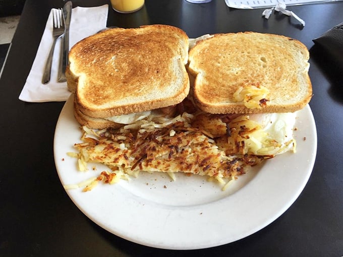 Breakfast sandwiches that understand the assignment: golden toast, generous filling, and hash browns that could make a potato farmer weep with pride.