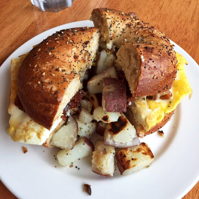 The breakfast sandwich that makes Monday mornings bearable &ndash; perfectly toasted everything bagel, fluffy eggs, and home fries that demand attention.