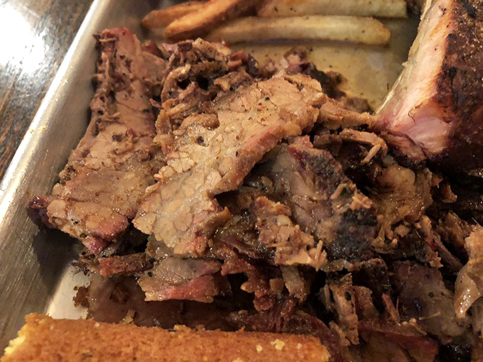 Brisket sliced thin enough to read through but thick enough to satisfy, with bark that deserves its own fan club. 